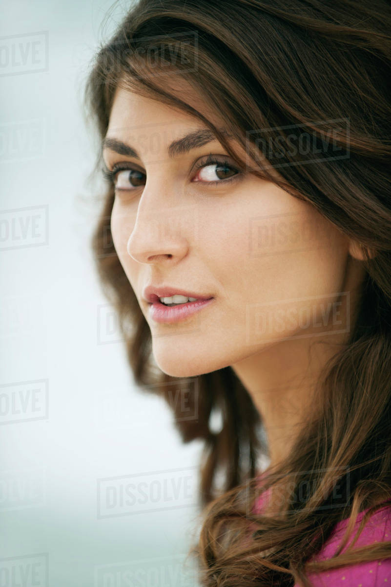 Woman glancing sideways at camera, portrait - Royalty-free Stock Photo ...