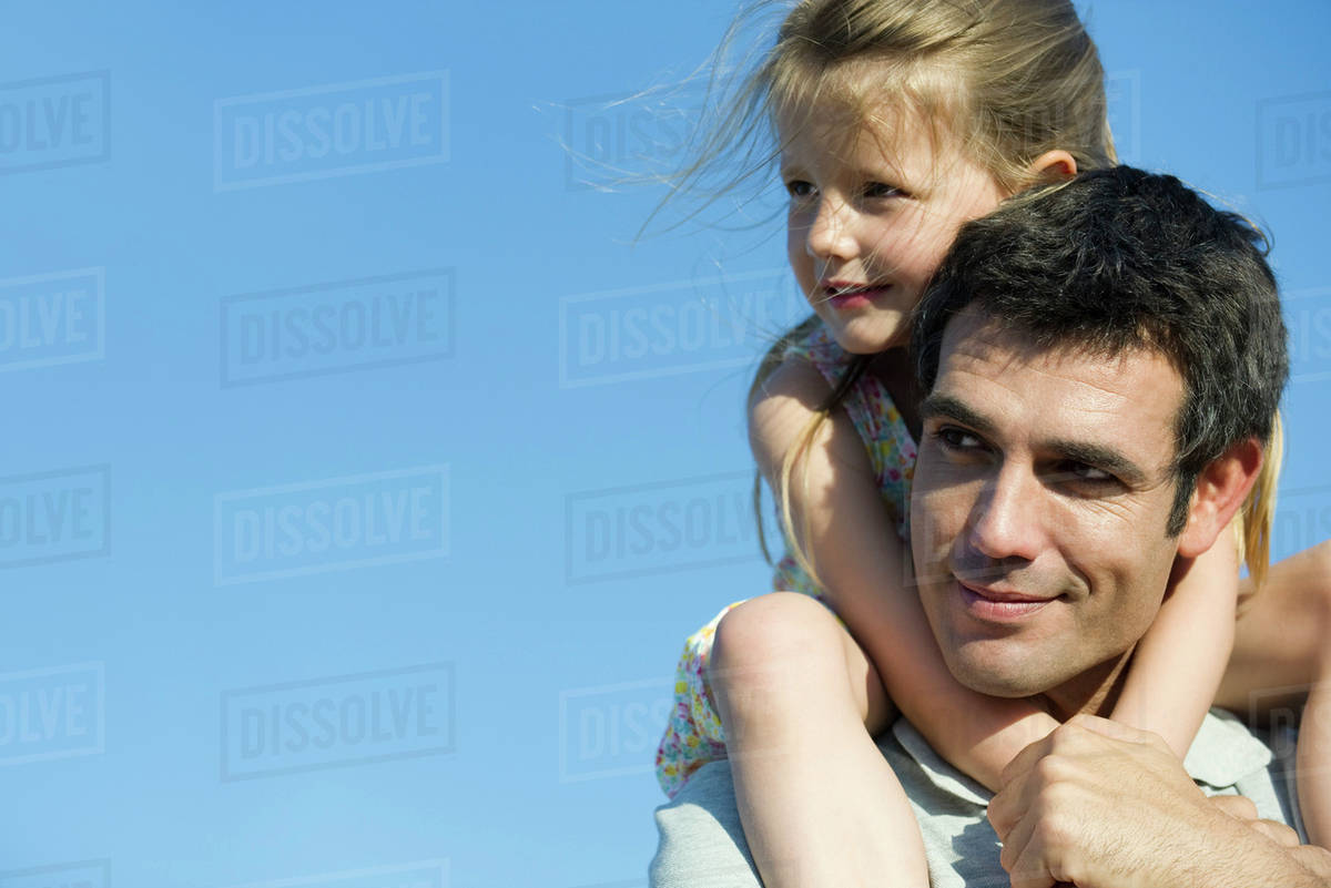 Father carrying daughter on his shoulders - Royalty-free Stock Photo | Dissolve