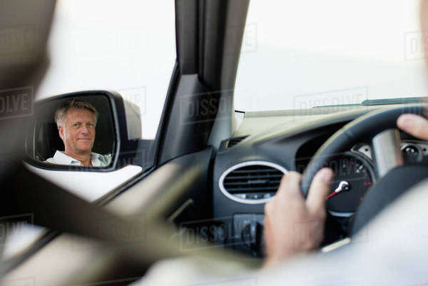 Man driving car, reflected in driver's side mirror - Royalty-free Stock ...
