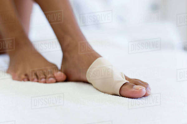 Woman's foot wrapped in brace for injured toe, low section - Royalty ...