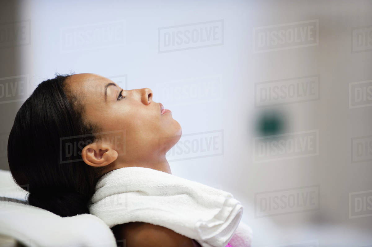 Woman with towel around neck, side view - Royalty-free Stock Photo ...