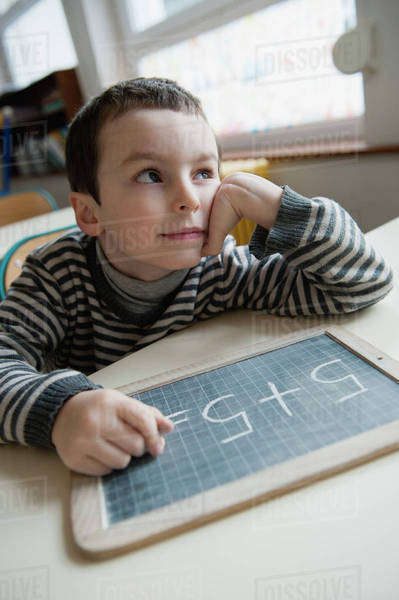 Boy solving math problem - Royalty-free Stock Photo | Dissolve