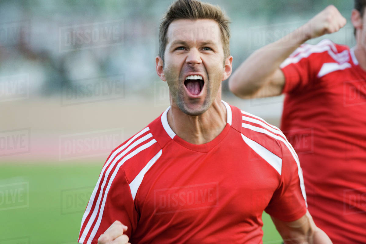 Soccer player cheering - Stock Photo - Dissolve