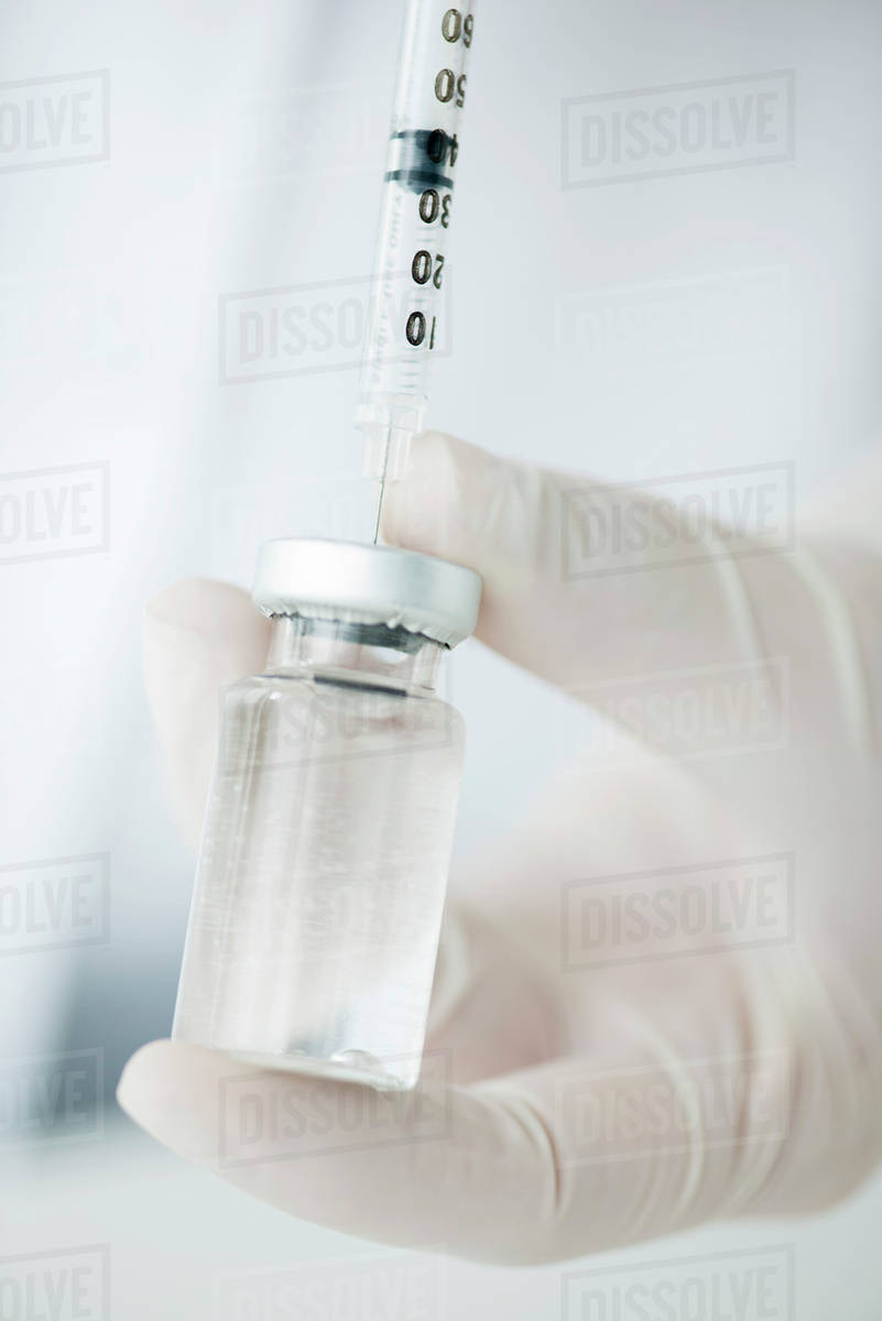 Extracting liquid from vial with syringe - Royalty-free Stock Photo ...