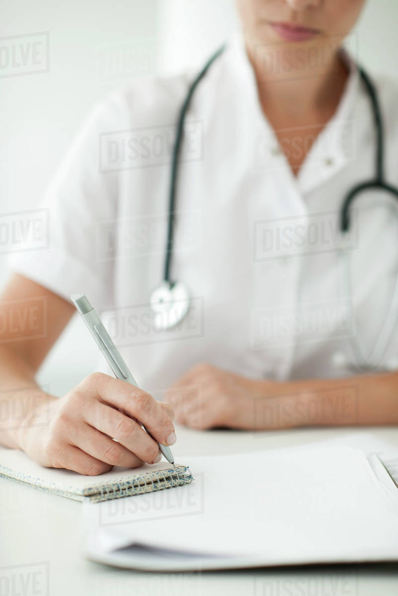 Doctor writing notes on notepad, cropped - Royalty-free Stock Photo ...