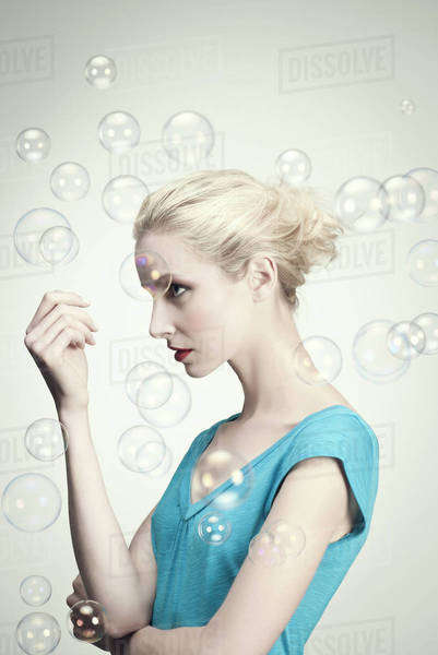 Young woman surrounded by bubbles, portrait - Royalty-free Stock Photo ...