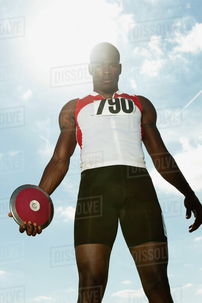 Male athlete holding discus, low angle view - Royalty-free Stock Photo ...