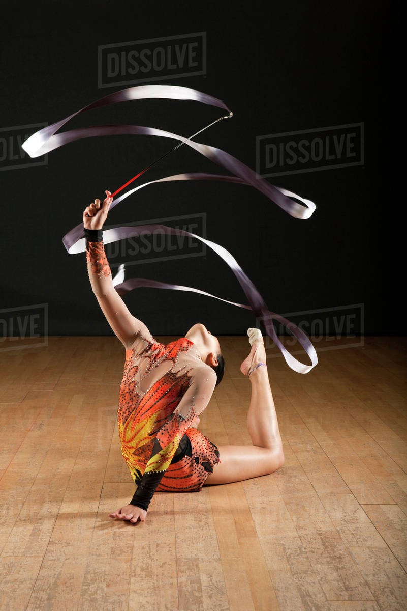 Gymnast bending backwards on floor, twirling ribbon - Royalty-free ...
