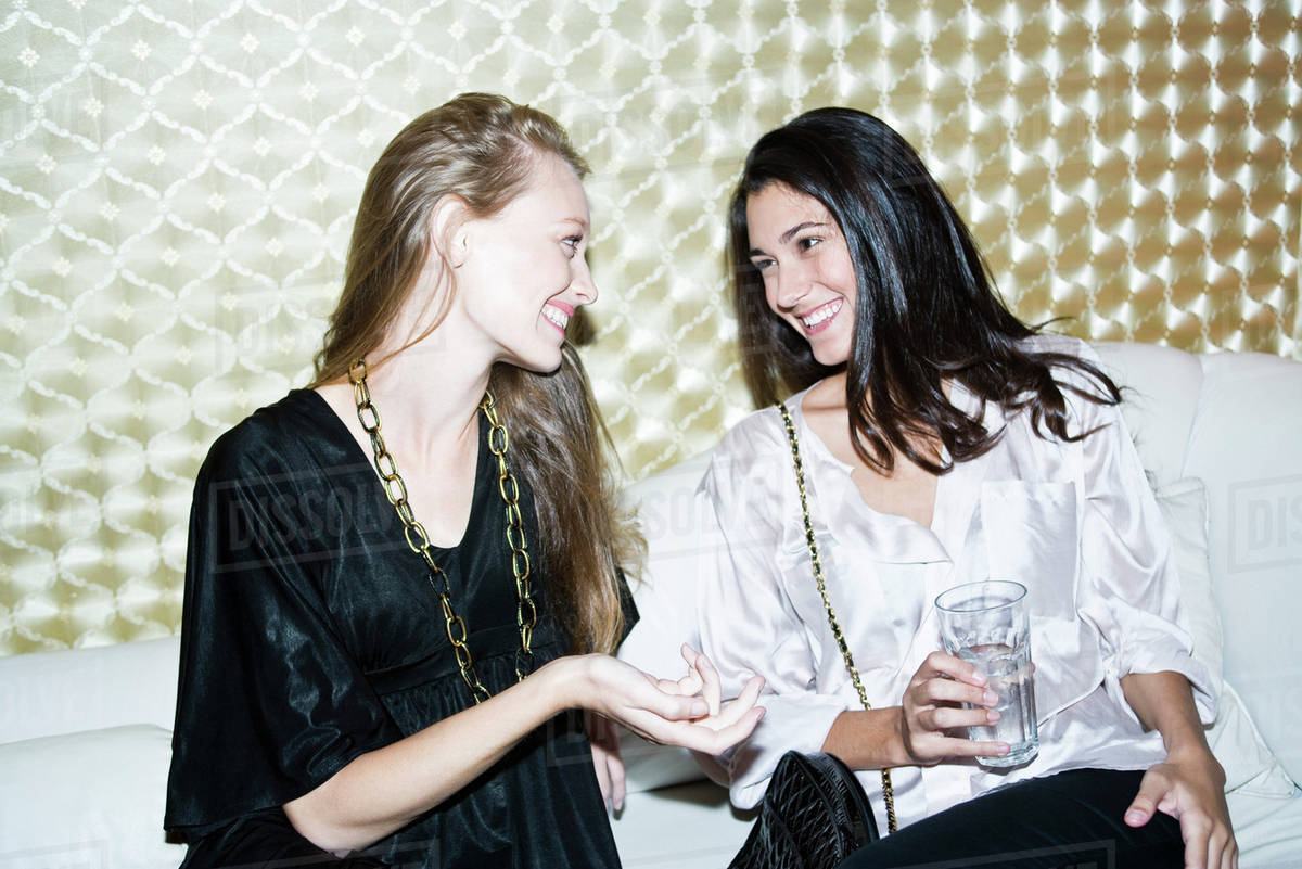 Friends chatting at nightclub - Stock Photo - Dissolve