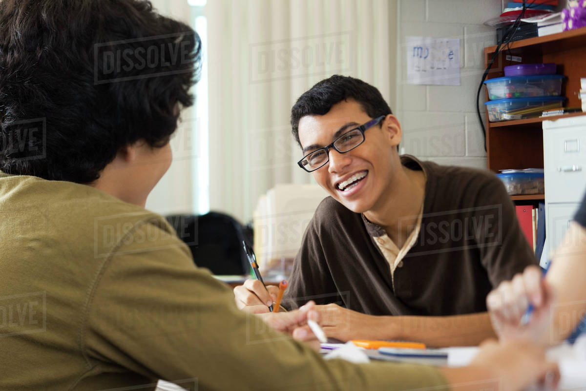 Student laughing with fellow classmates - Stock Photo - Dissolve