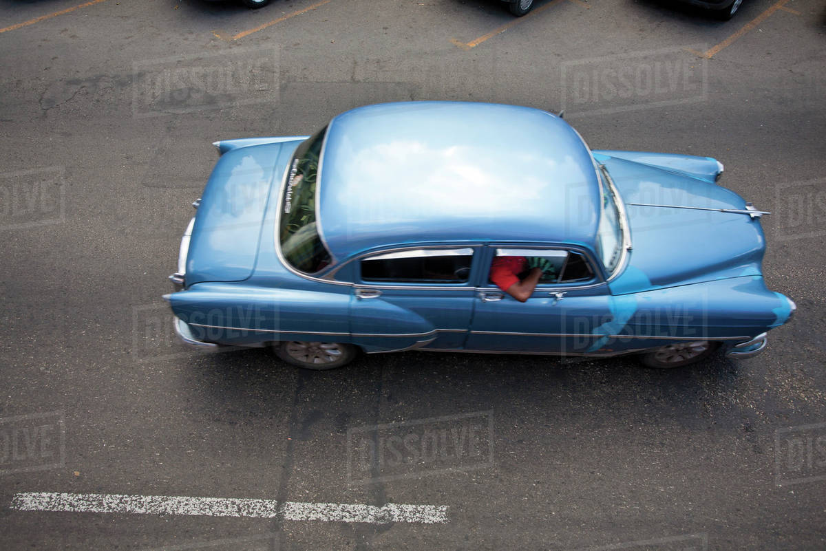 Vintage car driving on street - Stock Photo - Dissolve
