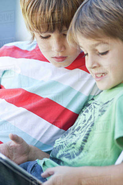 Boys using digital tablet - Royalty-free Stock Photo | Dissolve
