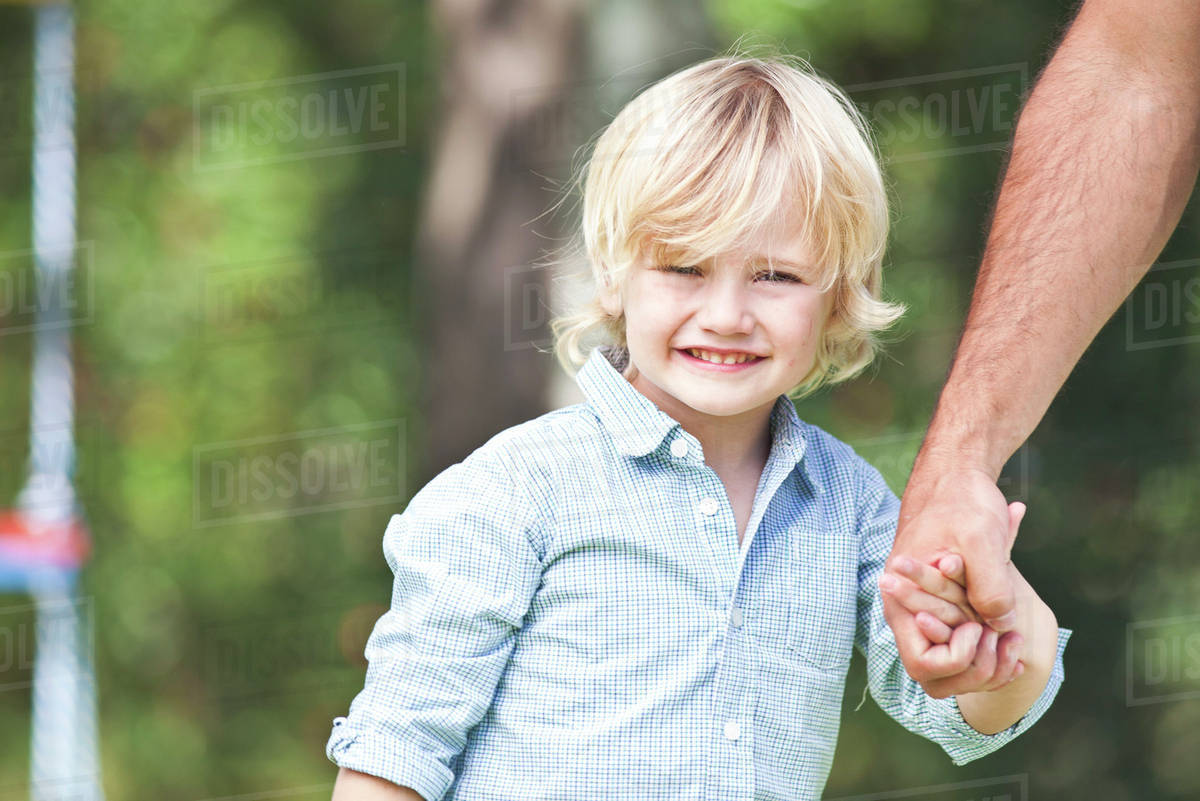 Little boy holding father's hand - Royalty-free Stock Photo | Dissolve