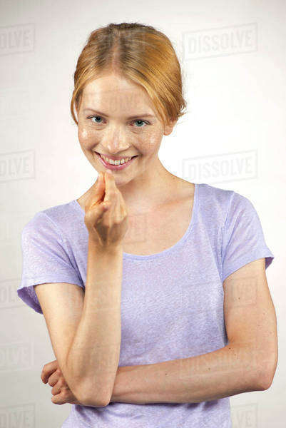 Woman beckoning with her finger, portrait - Stock Photo - Dissolve