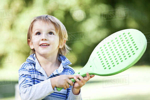 Boy holding racket - Royalty-free Stock Photo | Dissolve