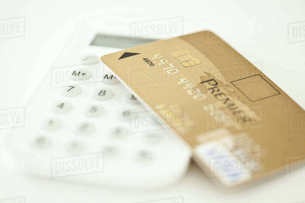 Credit card resting on calculator - Royalty-free Stock Photo | Dissolve