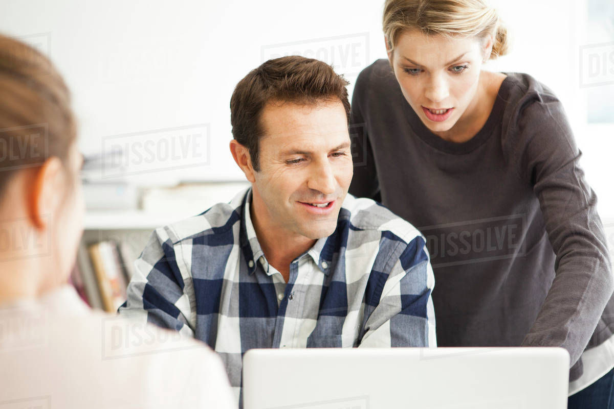 Colleagues collaborating on work project - Stock Photo - Dissolve