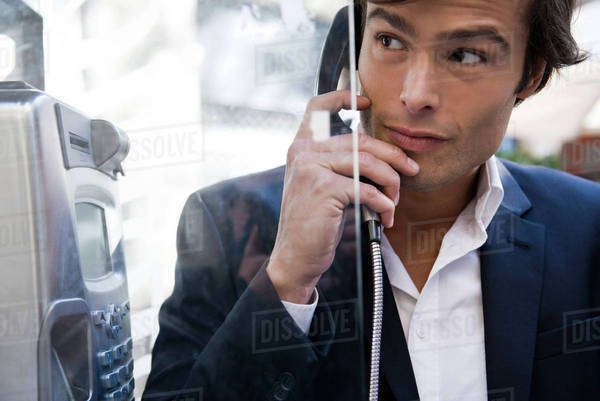 Man using pay phone - Royalty-free Stock Photo | Dissolve