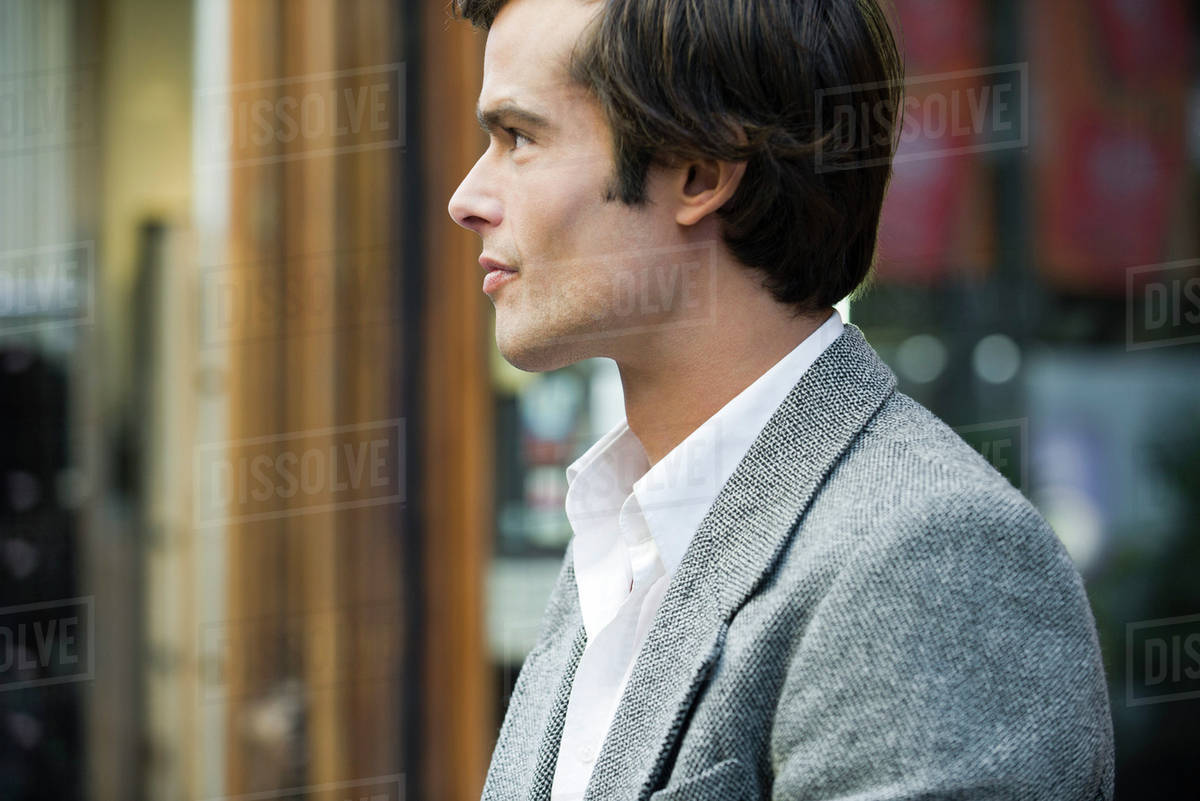 Man walking outdoors, profile - Stock Photo - Dissolve
