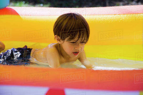 Little boy playing in wading pool - Royalty-free Stock Photo | Dissolve