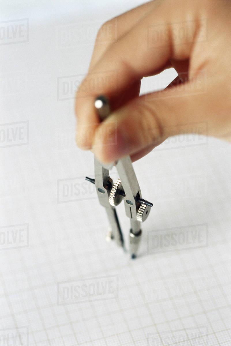 Hand holding drawing compass - Royalty-free Stock Photo | Dissolve