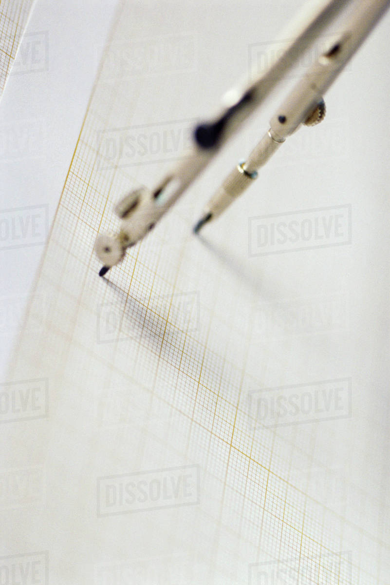 Drawing compass on graph paper - Royalty-free Stock Photo | Dissolve