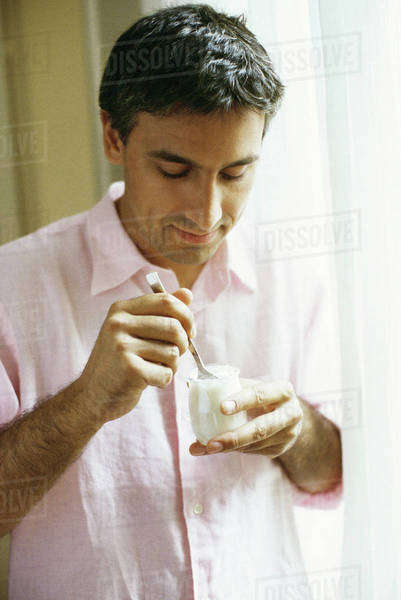 Man eating yogurt - Royalty-free Stock Photo | Dissolve