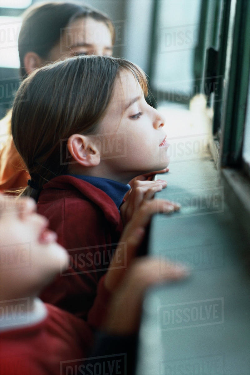Children peering over high windowsill - Royalty-free Stock Photo | Dissolve