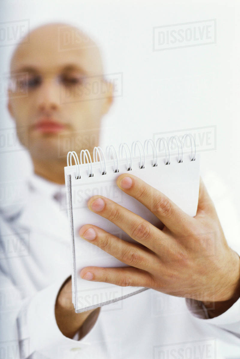 Researcher writing notes in notebook - Royalty-free Stock Photo | Dissolve