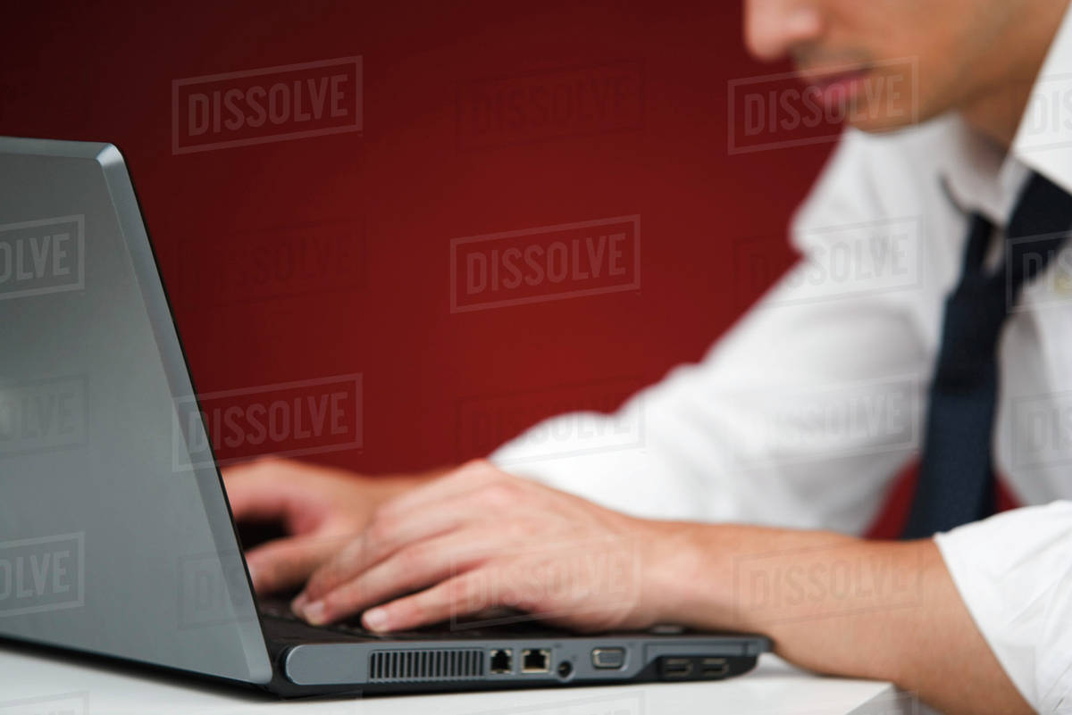 Man using laptop computer - Royalty-free Stock Photo | Dissolve