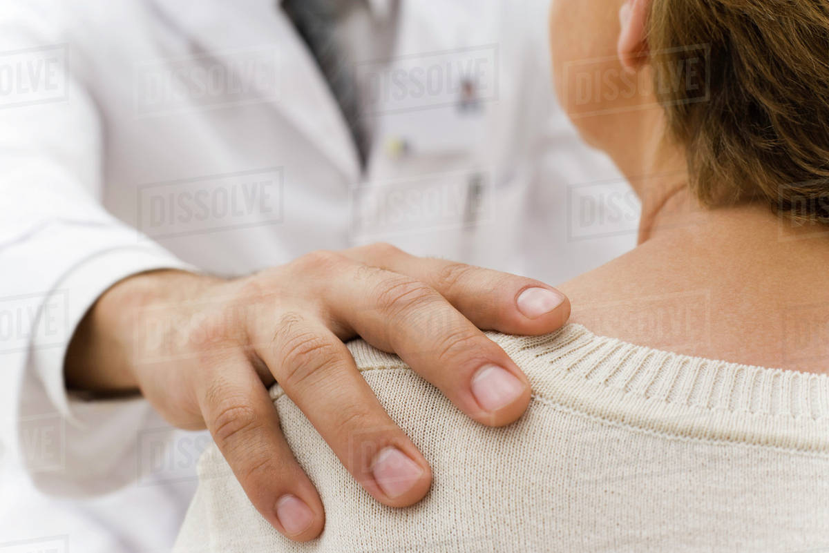 Doctor's hand on patient's shoulder - Royalty-free Stock Photo | Dissolve