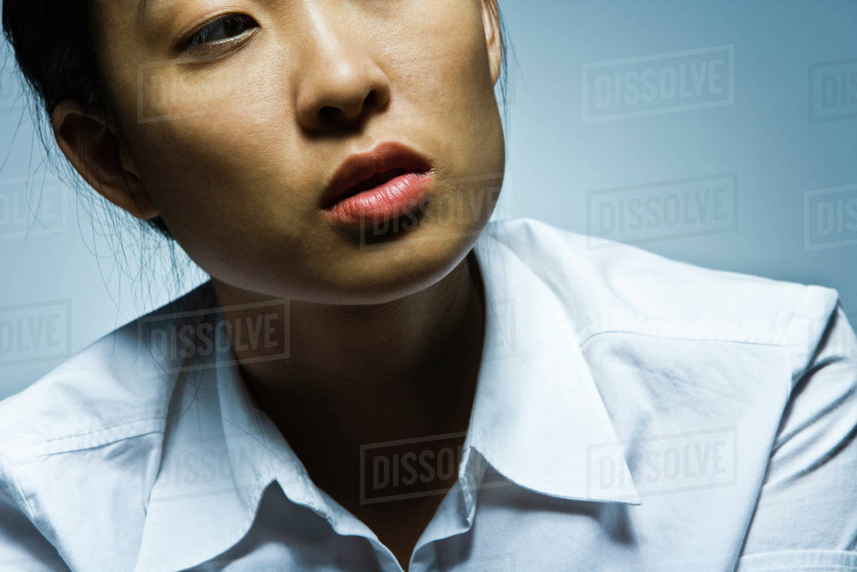 Young woman looking around with air of curiosity - Royalty-free Stock ...