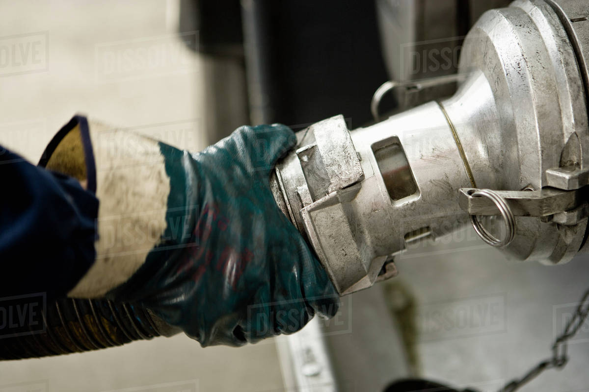 Connecting hose to fuel tanker outlet - Royalty-free Stock Photo | Dissolve