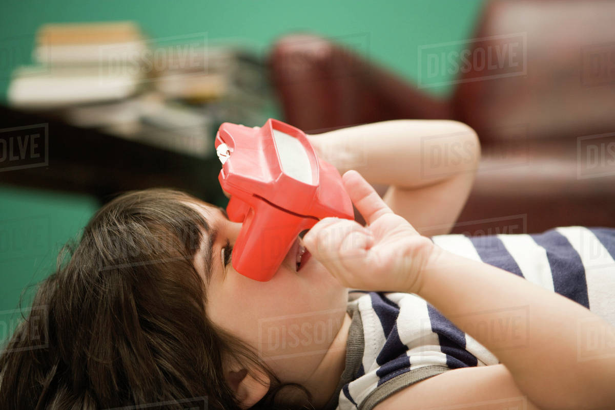Child looking through toy viewfinder - Royalty-free Stock Photo | Dissolve