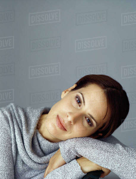 Woman resting head on arms, portrait - Royalty-free Stock Photo | Dissolve