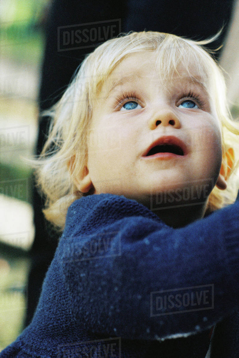 Little girl looking up, portrait - Royalty-free Stock Photo | Dissolve