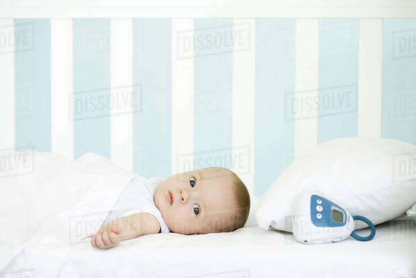 Infant lying in crib, looking at camera - Royalty-free Stock Photo ...