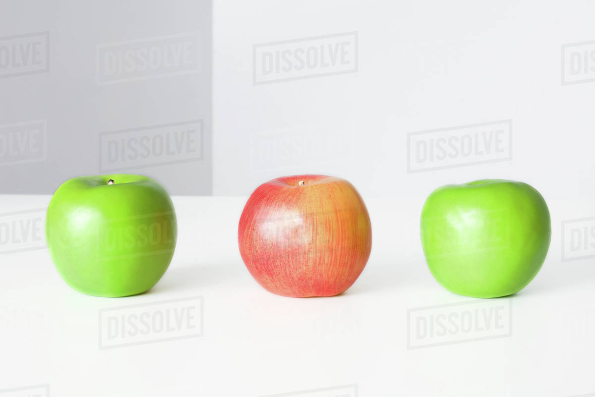 Three apples in a row, two green and one red, close-up - Royalty-free ...