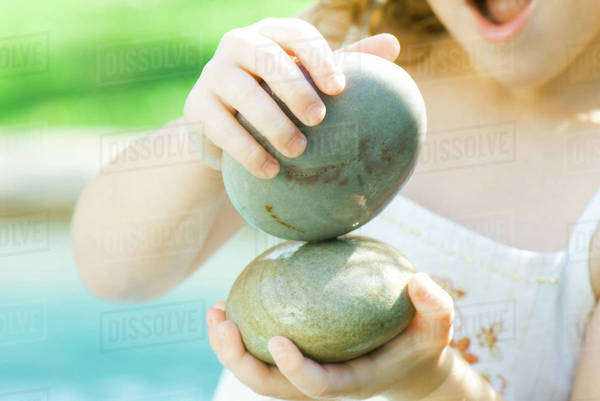 Child playing with stones - Royalty-free Stock Photo | Dissolve