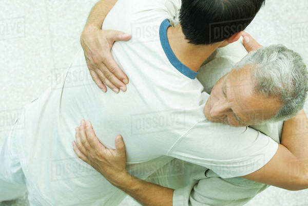 Two men hugging, high angle view - Royalty-free Stock Photo | Dissolve