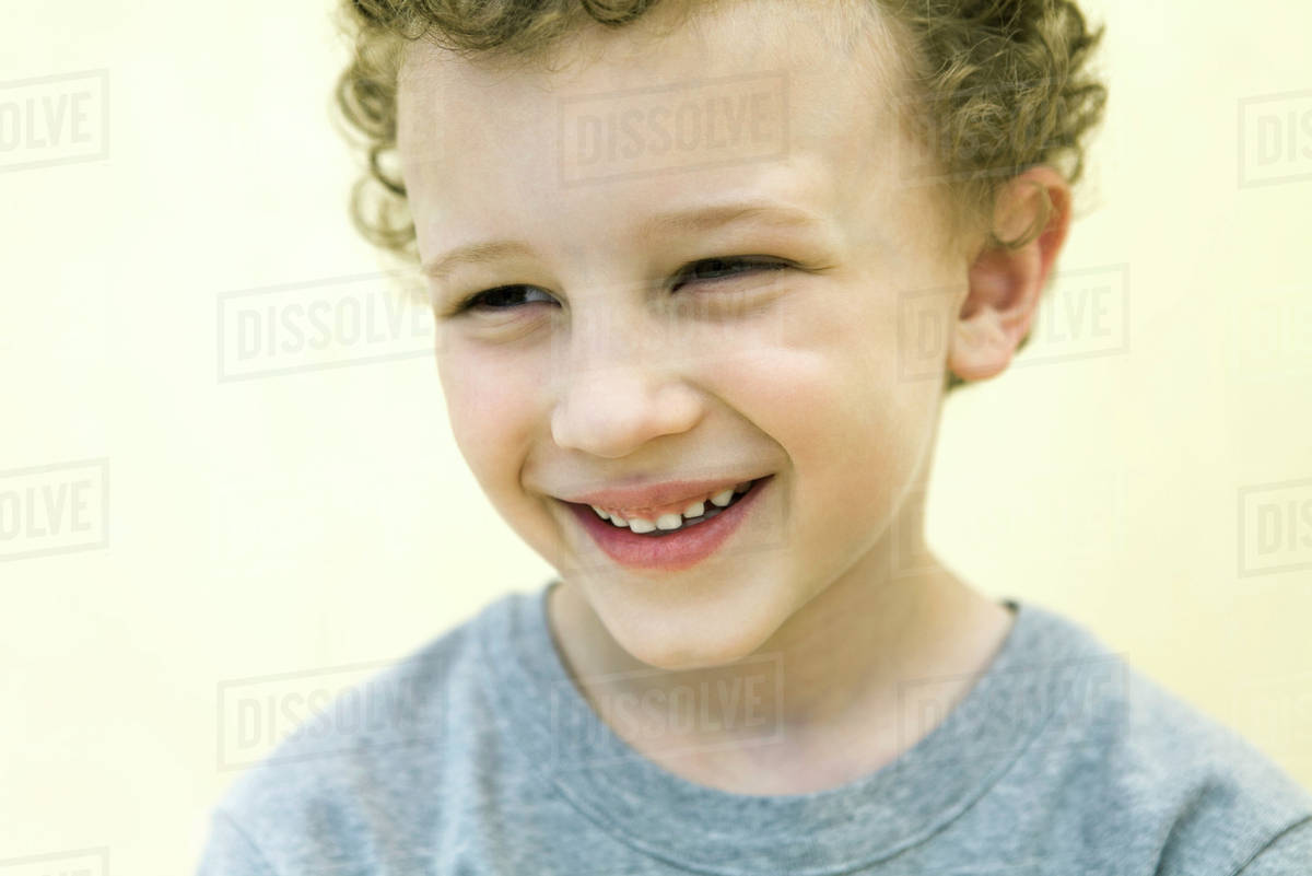 Little boy looking away and smiling, portrait - Stock Photo - Dissolve