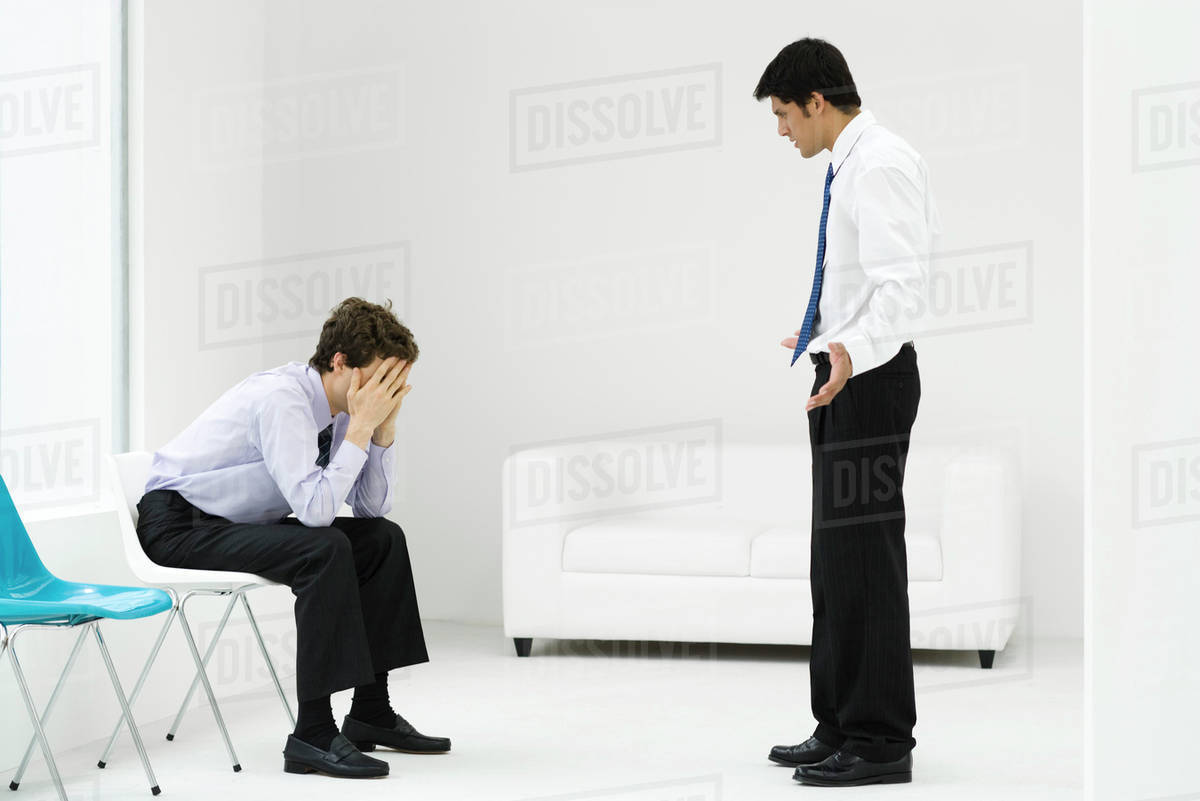 Professional man reprimanding employee, employee covering face with ...