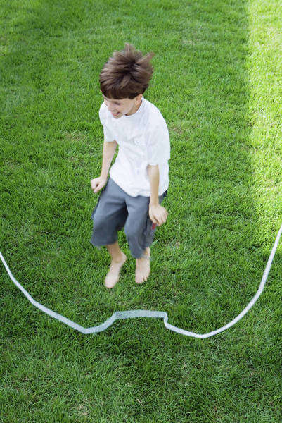 Boy jumping rope, high angle view - Royalty-free Stock Photo | Dissolve