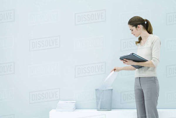 Professional woman throwing away document, holding folder - Stock Photo ...