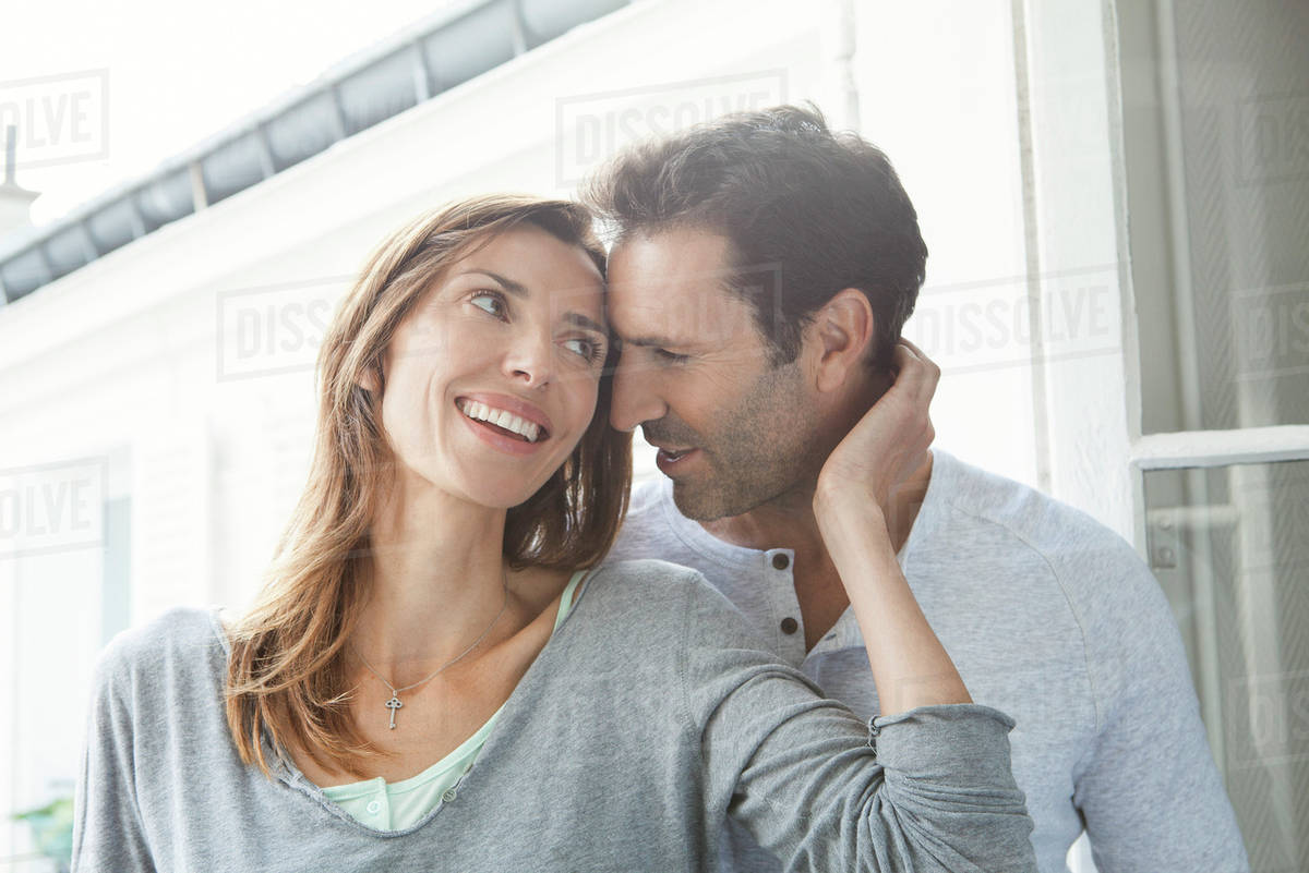 Couple sharing moment together by open window - Royalty-free Stock ...
