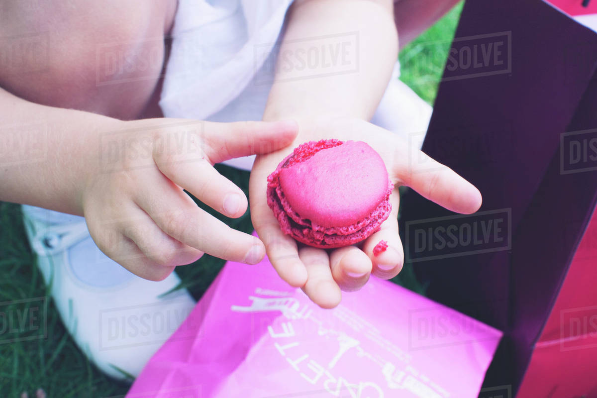 Child eating macaroon - Royalty-free Stock Photo | Dissolve
