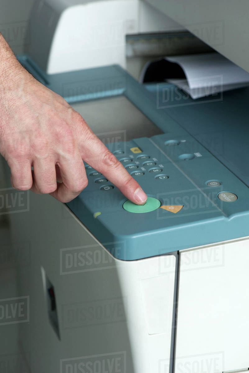 Using photocopier, close-up - Royalty-free Stock Photo | Dissolve