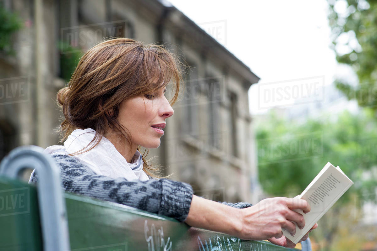 Tourist using guidebook - Stock Photo - Dissolve