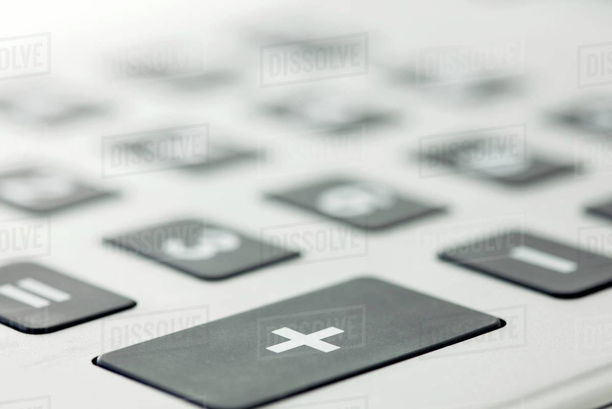 Close-up of addition button on calculator - Stock Photo - Dissolve
