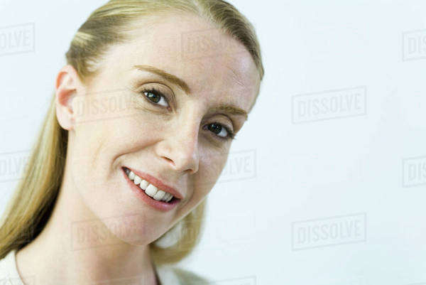Woman smiling at camera, head tilted, portrait - Royalty-free Stock ...